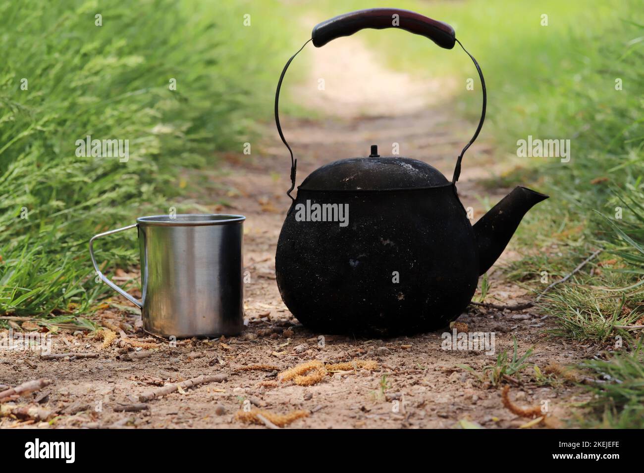 black camping teapot and metal cup Stock Photo - Alamy