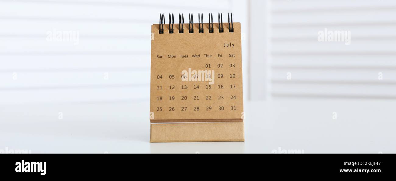 Calendar with open page of July month on light background Stock Photo ...