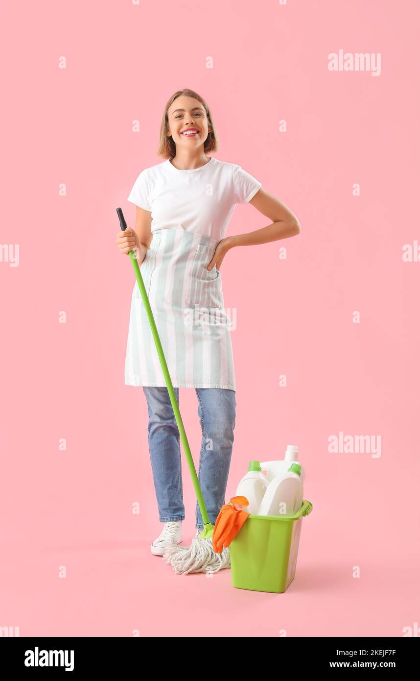 Pretty woman with mop on pink background Stock Photo - Alamy