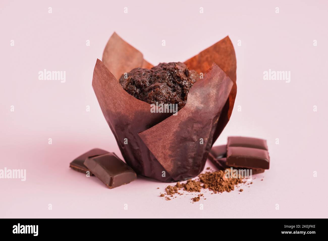 Delicious chocolate muffin on pink background Stock Photo - Alamy