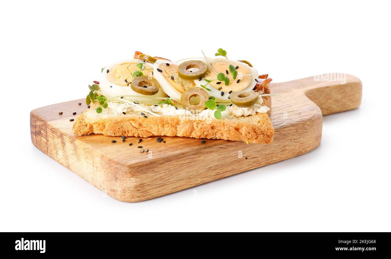 Wooden board of tasty toast with boiled egg, fried bacon and olives on ...