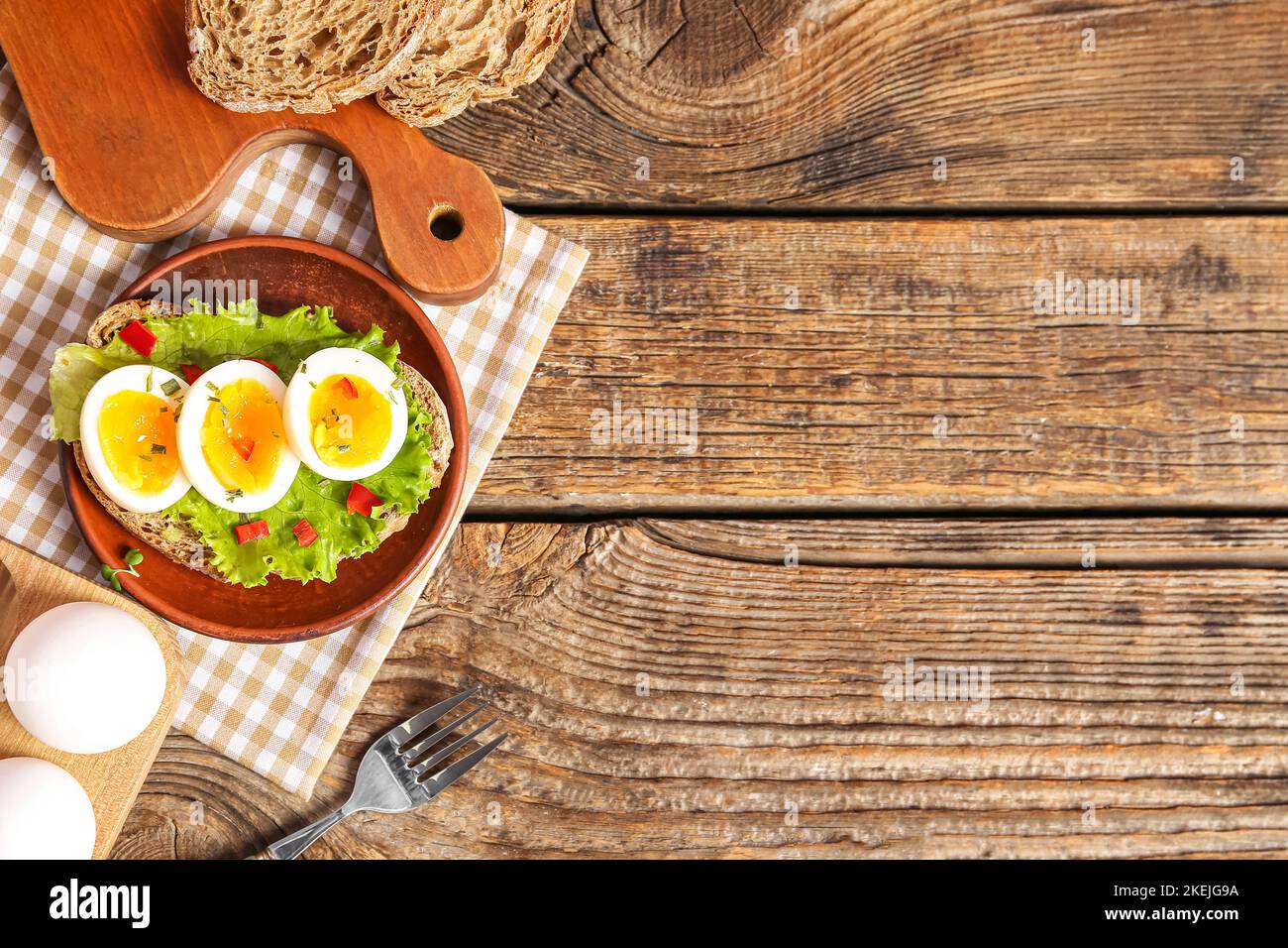 Plate of delicious toast with boiled egg on wooden background Stock ...