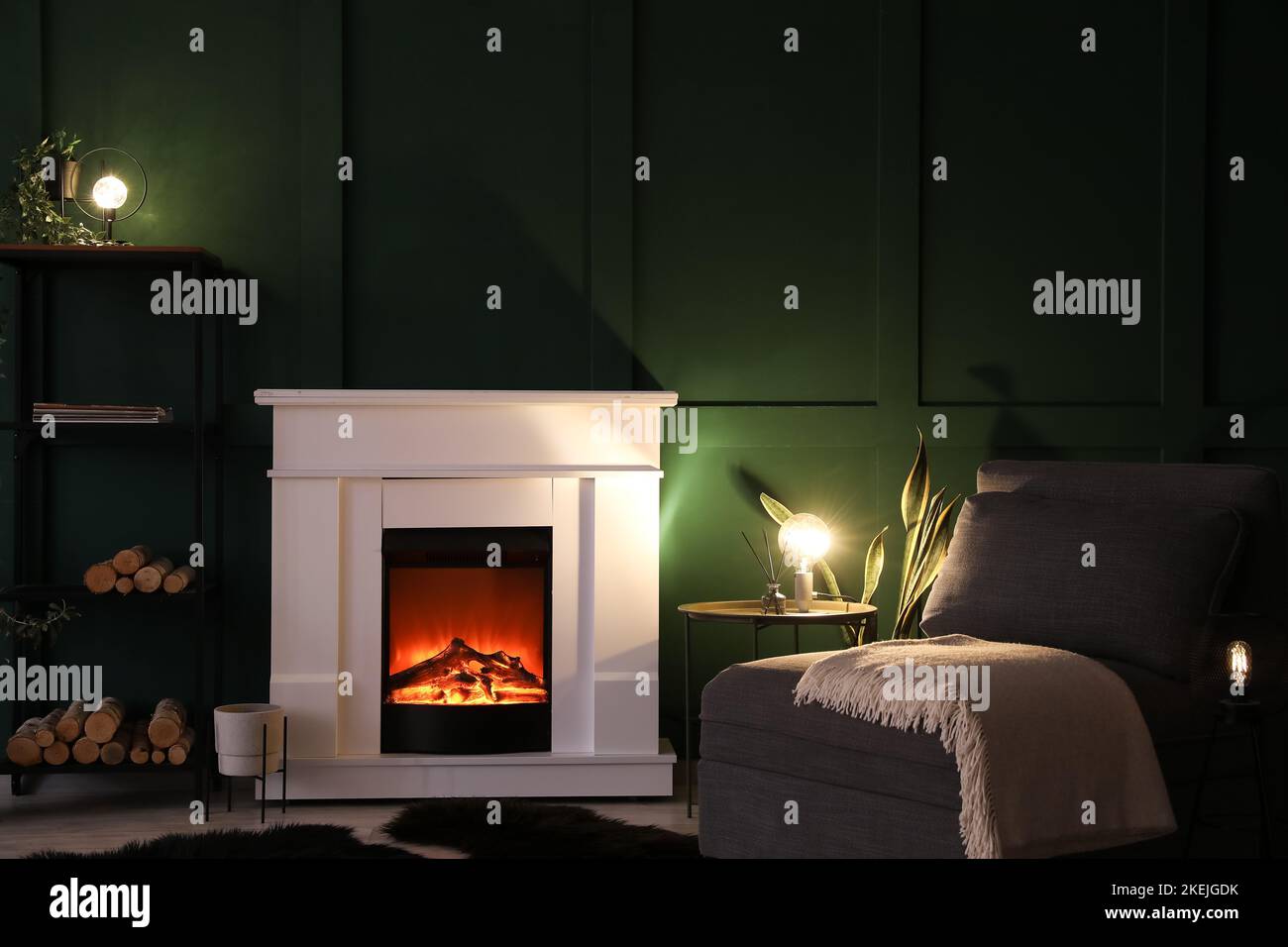 Interior of dark living room with fireplace, glowing lamps and shelving ...