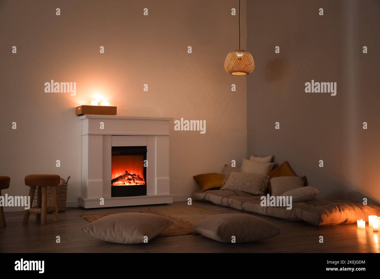 Interior of dark living room with fireplace, pillows and burning ...