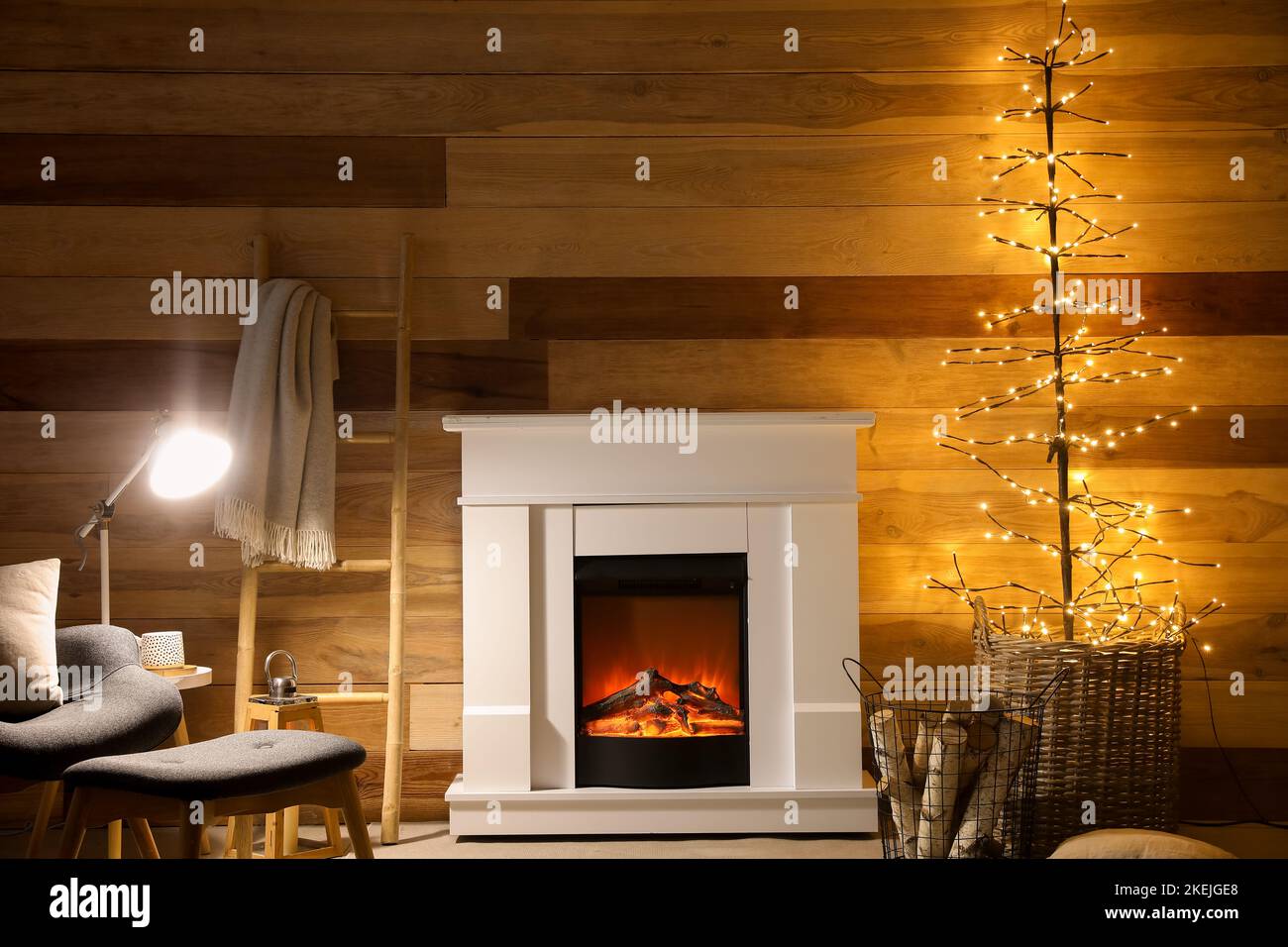 Interior of dark living room with fireplace, glowing lamps and ladder ...