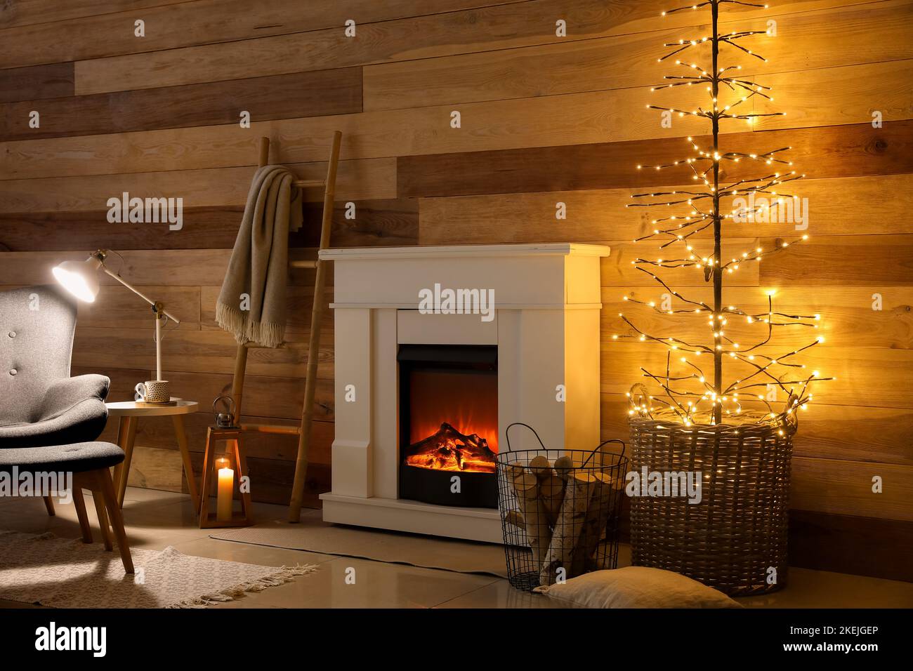Interior of dark living room with fireplace, glowing lamps and ladder ...