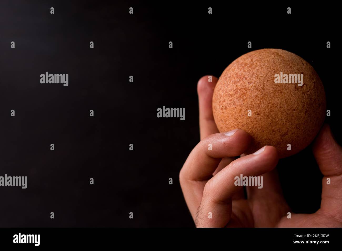 A man holding a Colombian traditional fried donuts on his hand with a ...