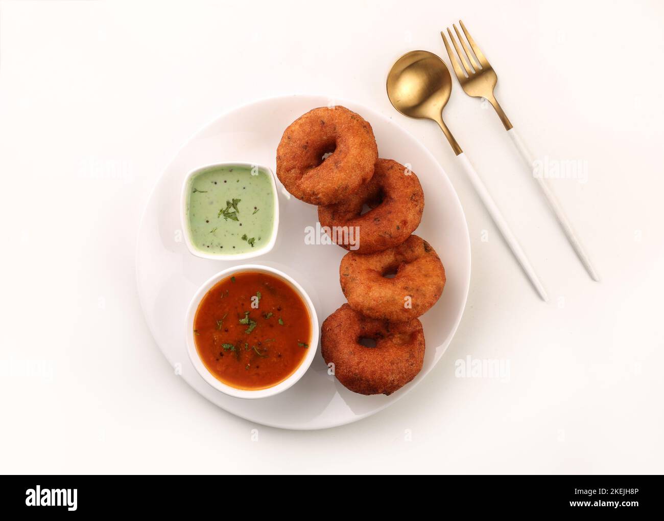 A top view of South Indian Medu vada on a plate with sauces Stock Photo ...