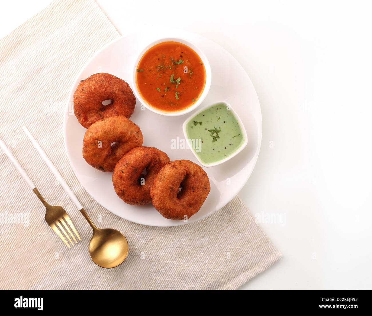 A top view of South Indian Medu vada on a plate with sauces Stock Photo ...