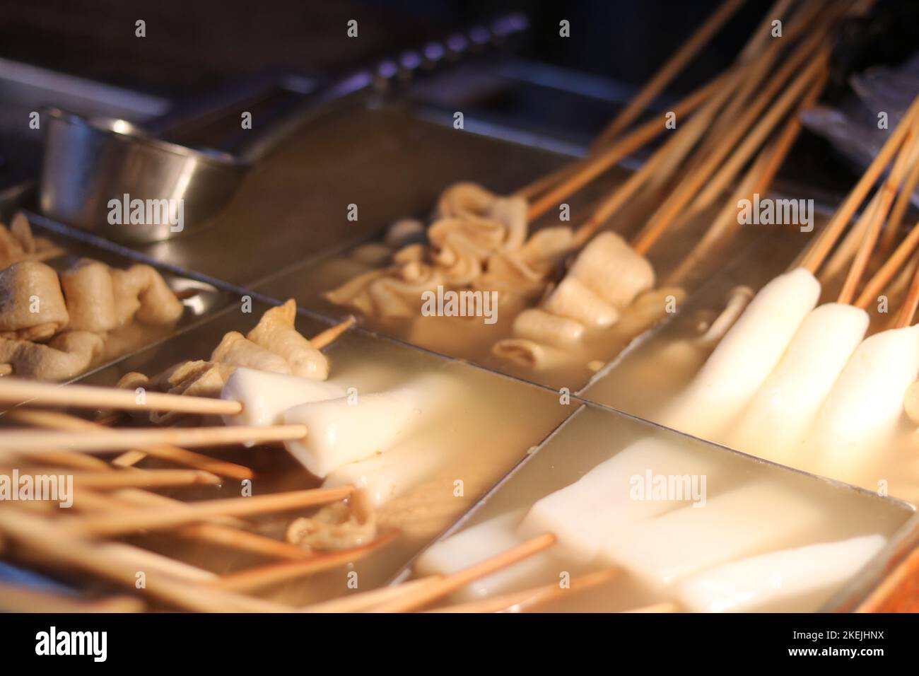 Bamboo fish skewers resting in liquid - South Korean street food Stock ...