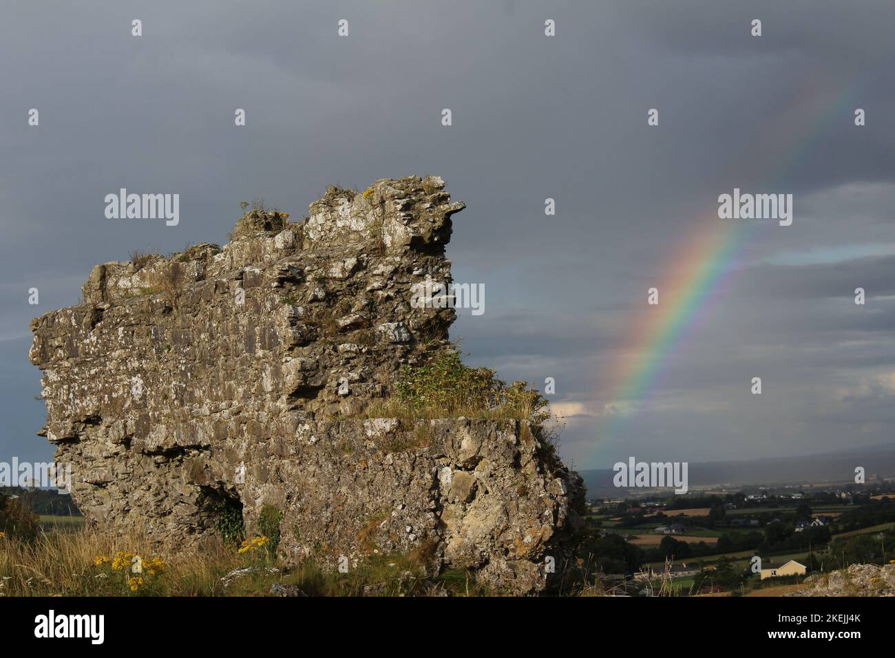 Stone ruins on a cloudy day and a rainbow after a rain Stock Photo - Alamy
