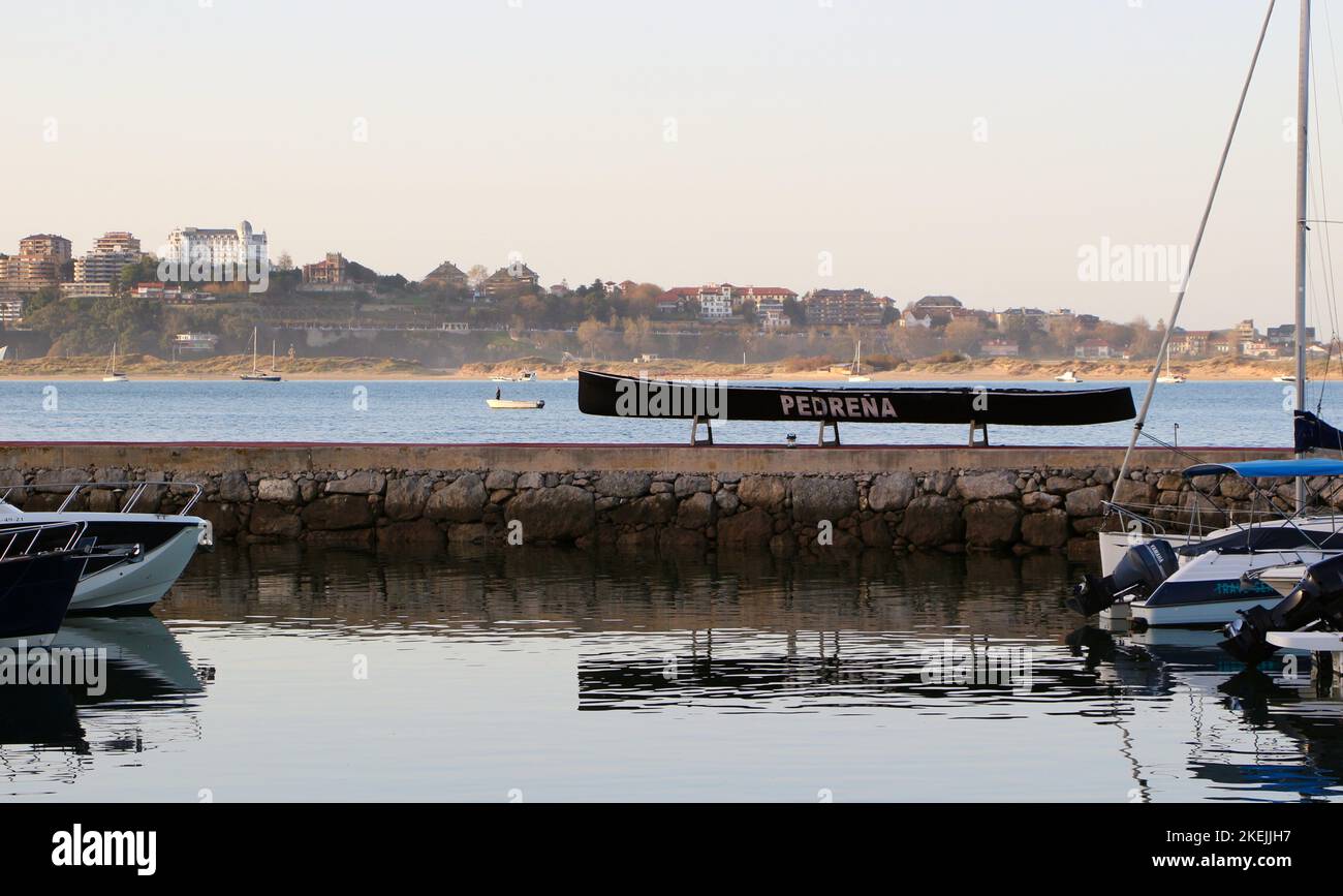 Traditional Trainera rowing boat on display on the edge of the marina ...