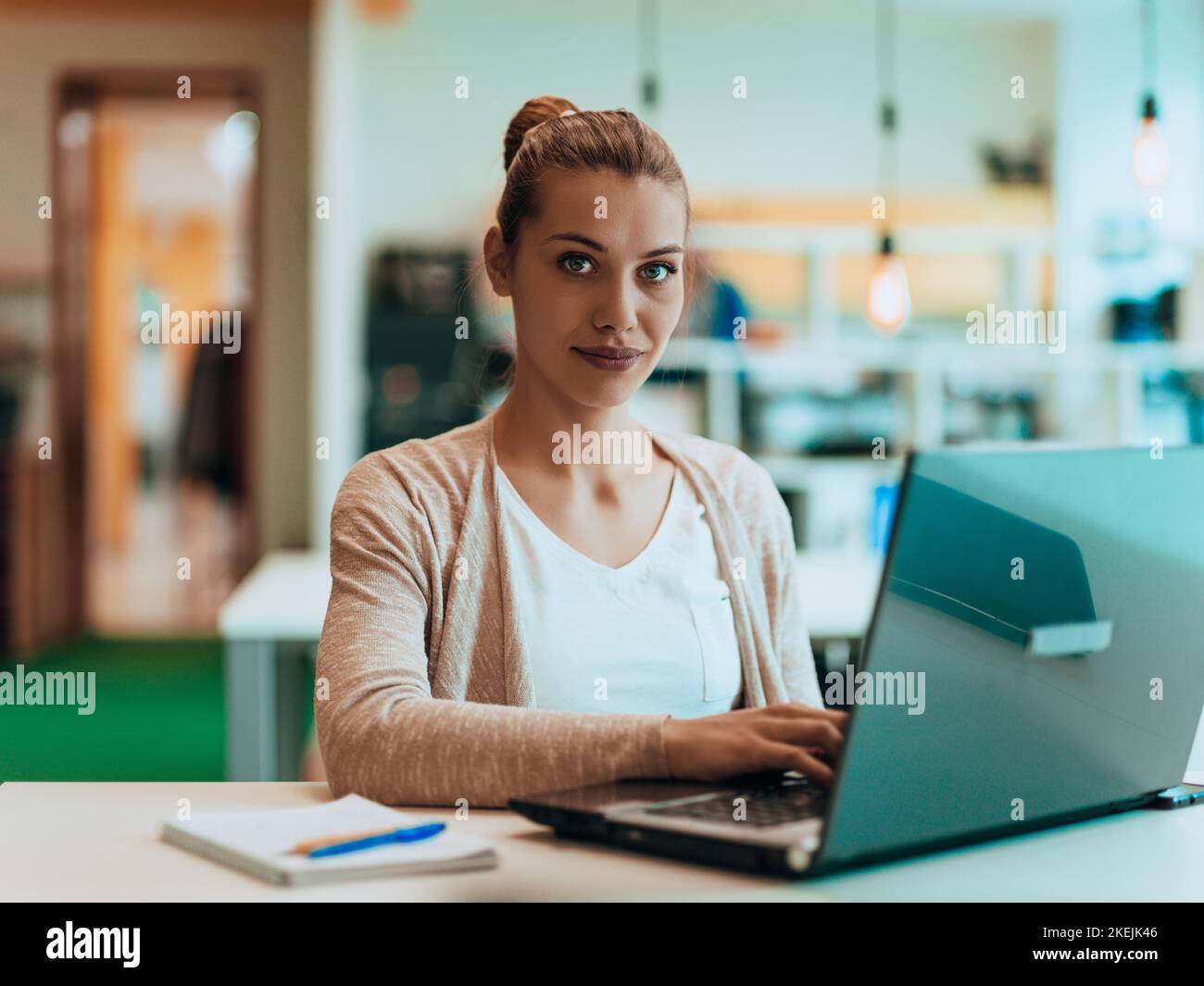 Blonde manager working behind her desk in a modern office Stock Photo ...