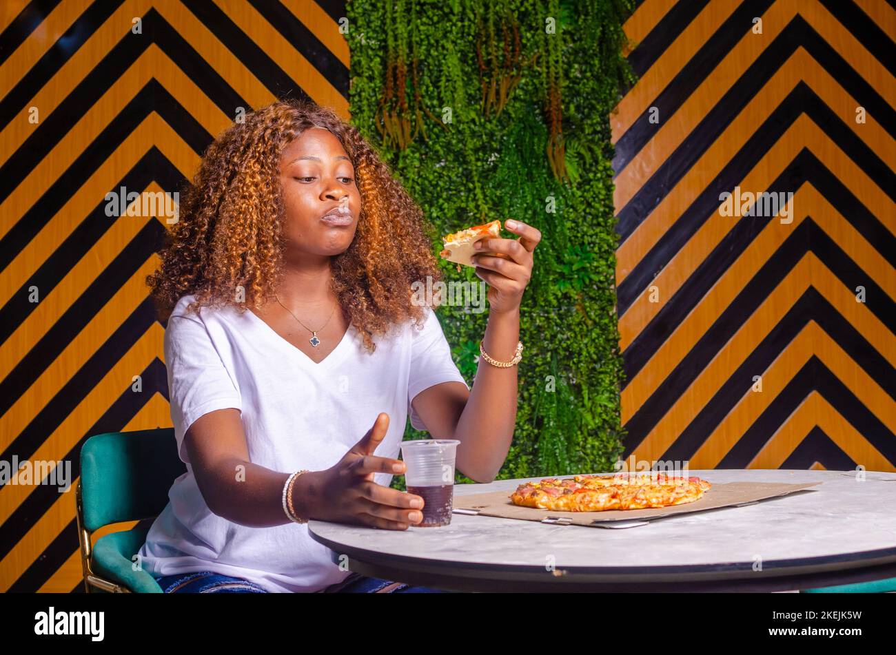 Young woman eating pizza model hi-res stock photography and images - Alamy