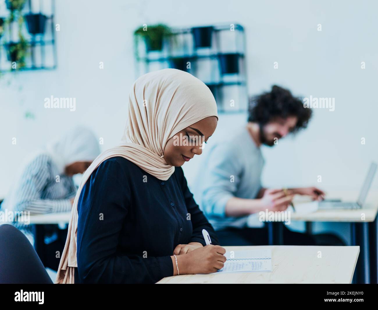 Photo of an African American Muslim woman being educated about business ...