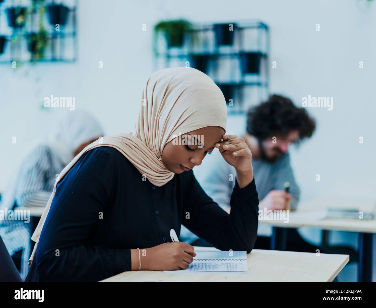 Photo of an African American Muslim woman being educated about business ...