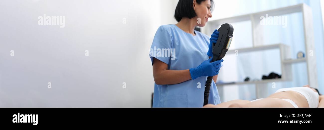 Woman beautician sets up laser hair removal Stock Photo - Alamy