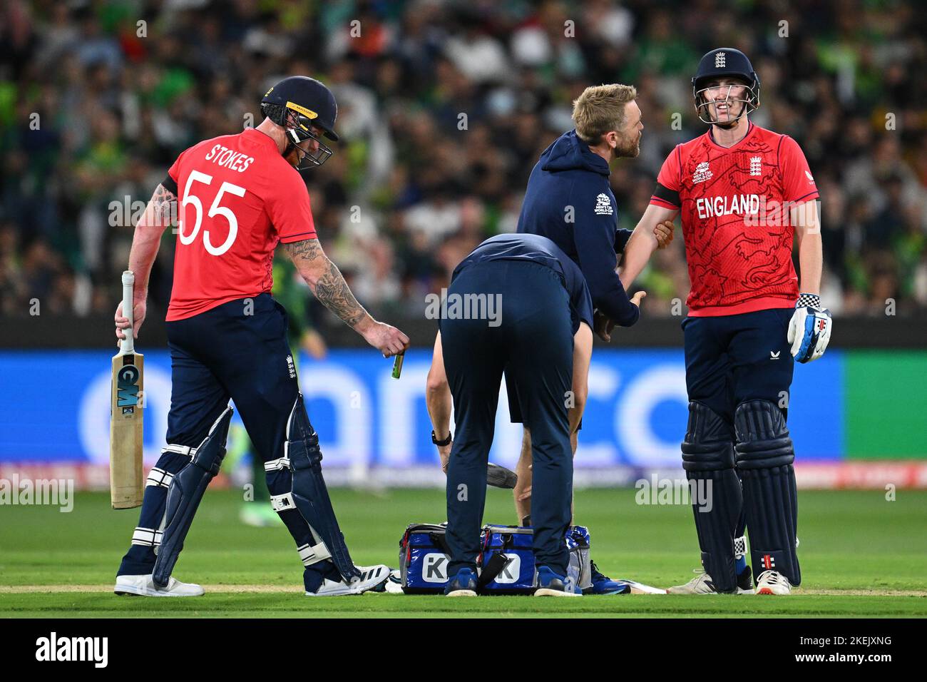 England's Harry Brook of England (right) is attended to by a trainer ...