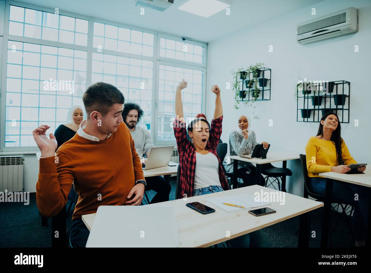 A group of diverse people listen to a lecture in business training ...