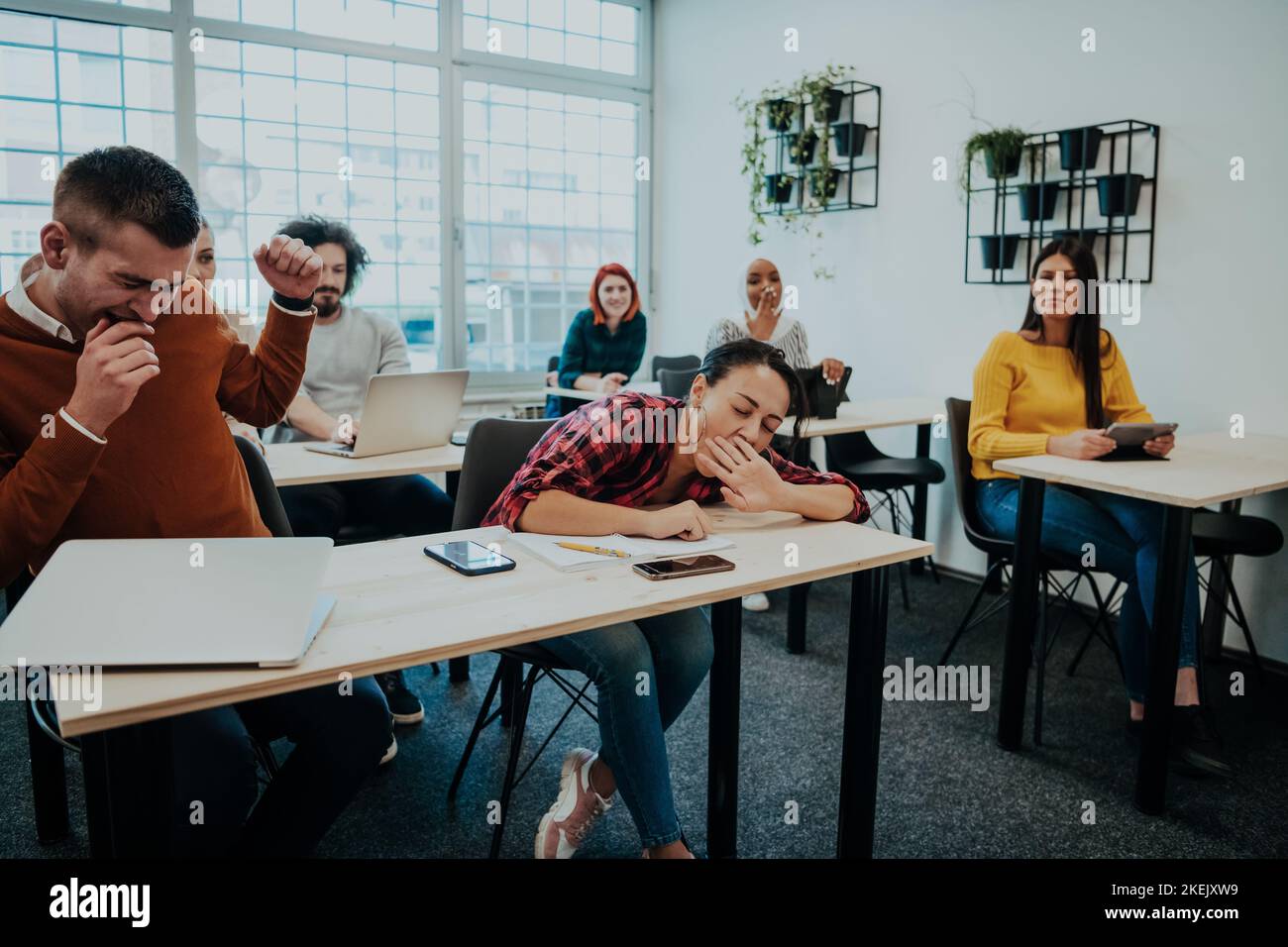 A group of diverse people listen to a lecture in business training ...