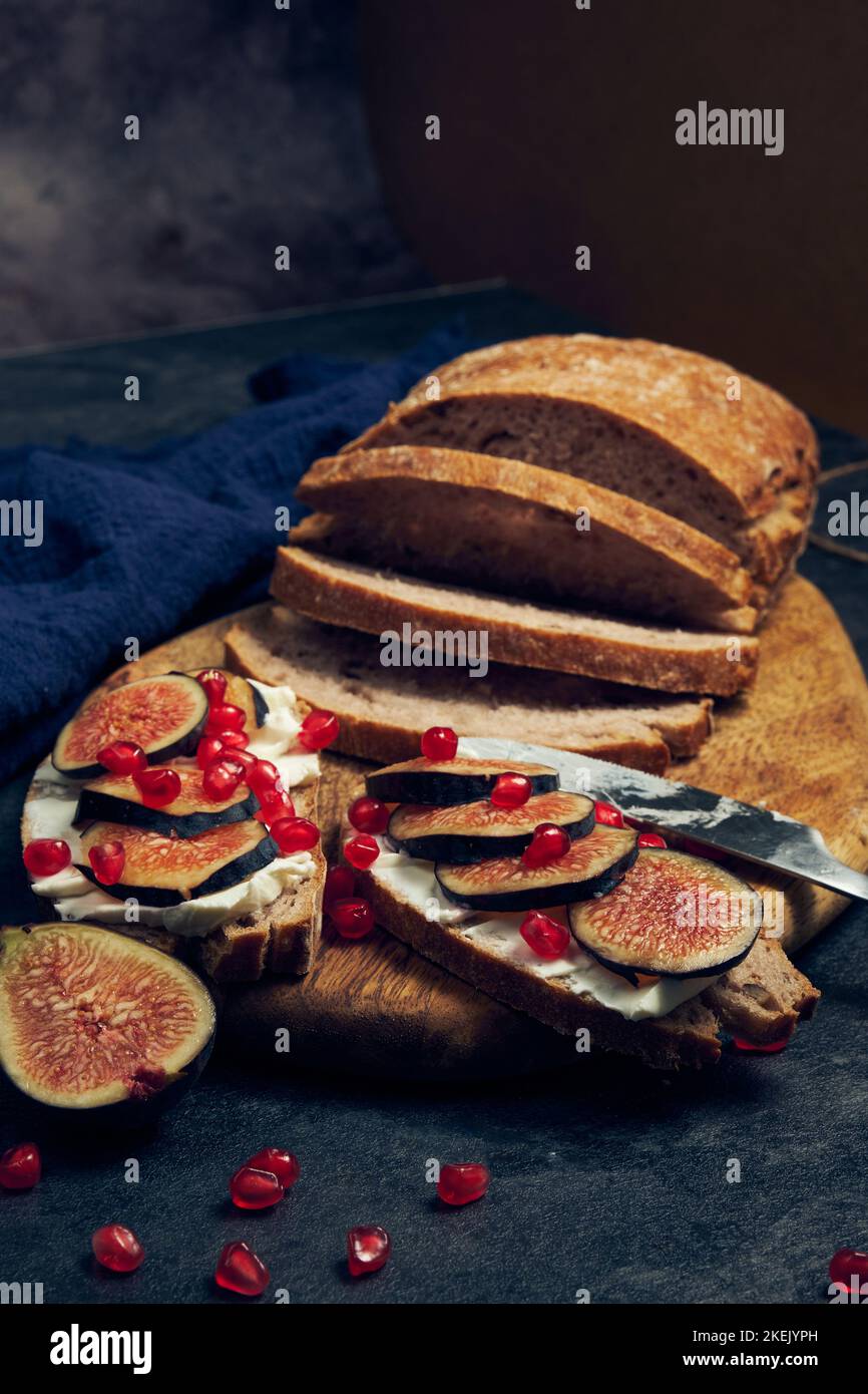 slices of rye bread with figs and pomegranate Stock Photo - Alamy