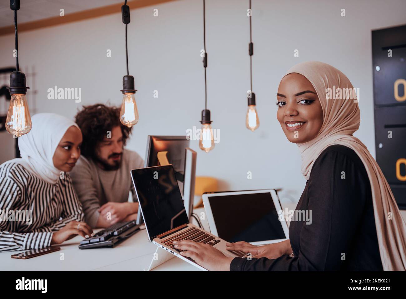 Group of multi-ethnic colleagues working on desktop computers, laptop ...