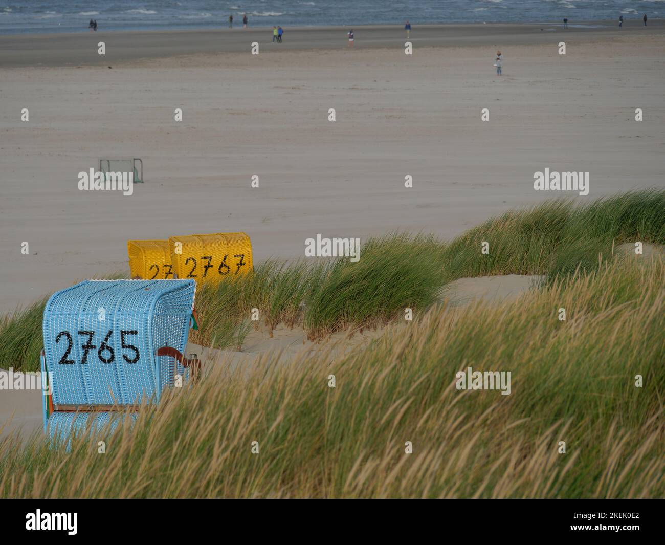 Small numbered booths on the Juist island beach around grass, Germany ...