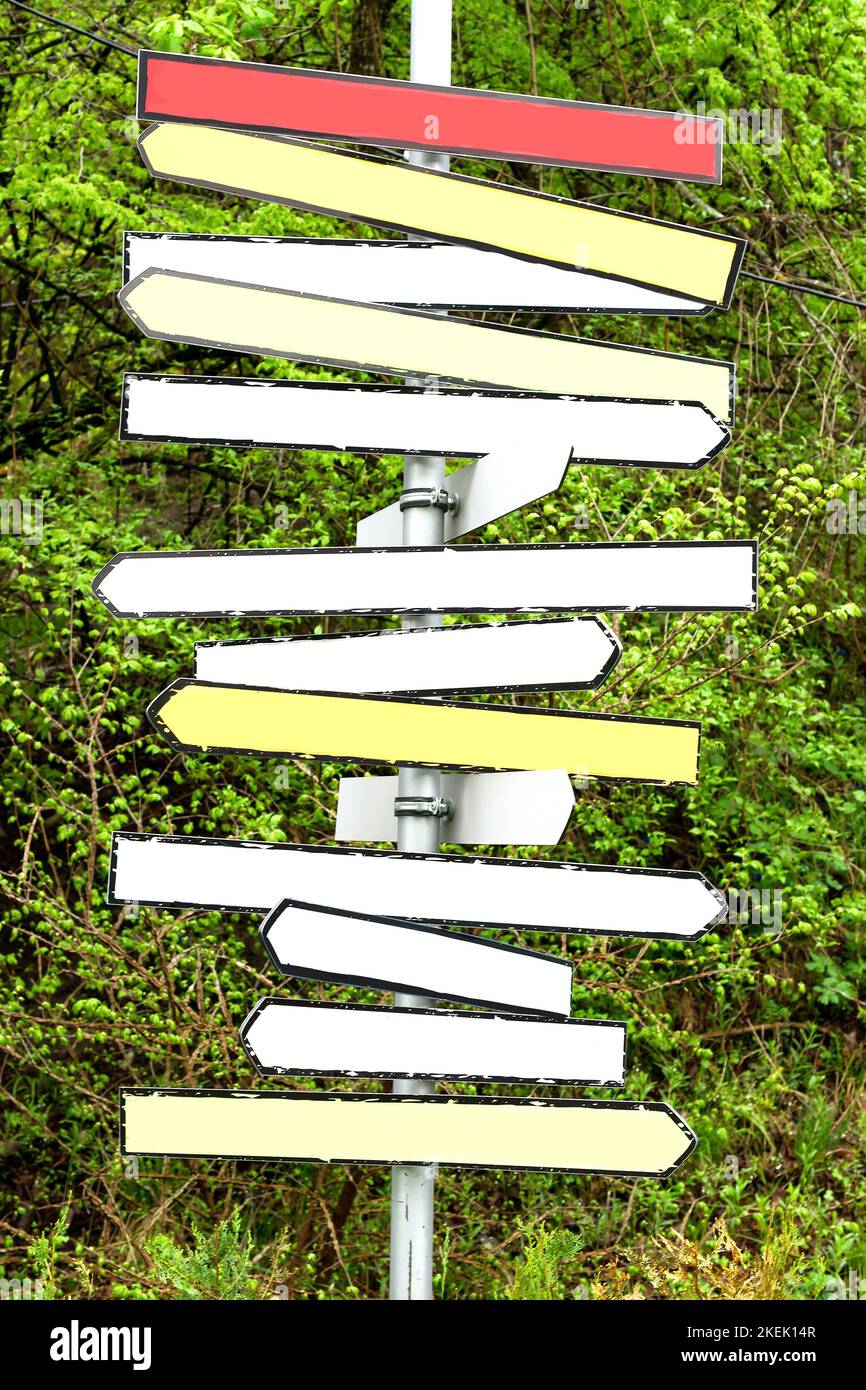 Multicolor blank signpost arrows in the forest. Metal road signs with ...