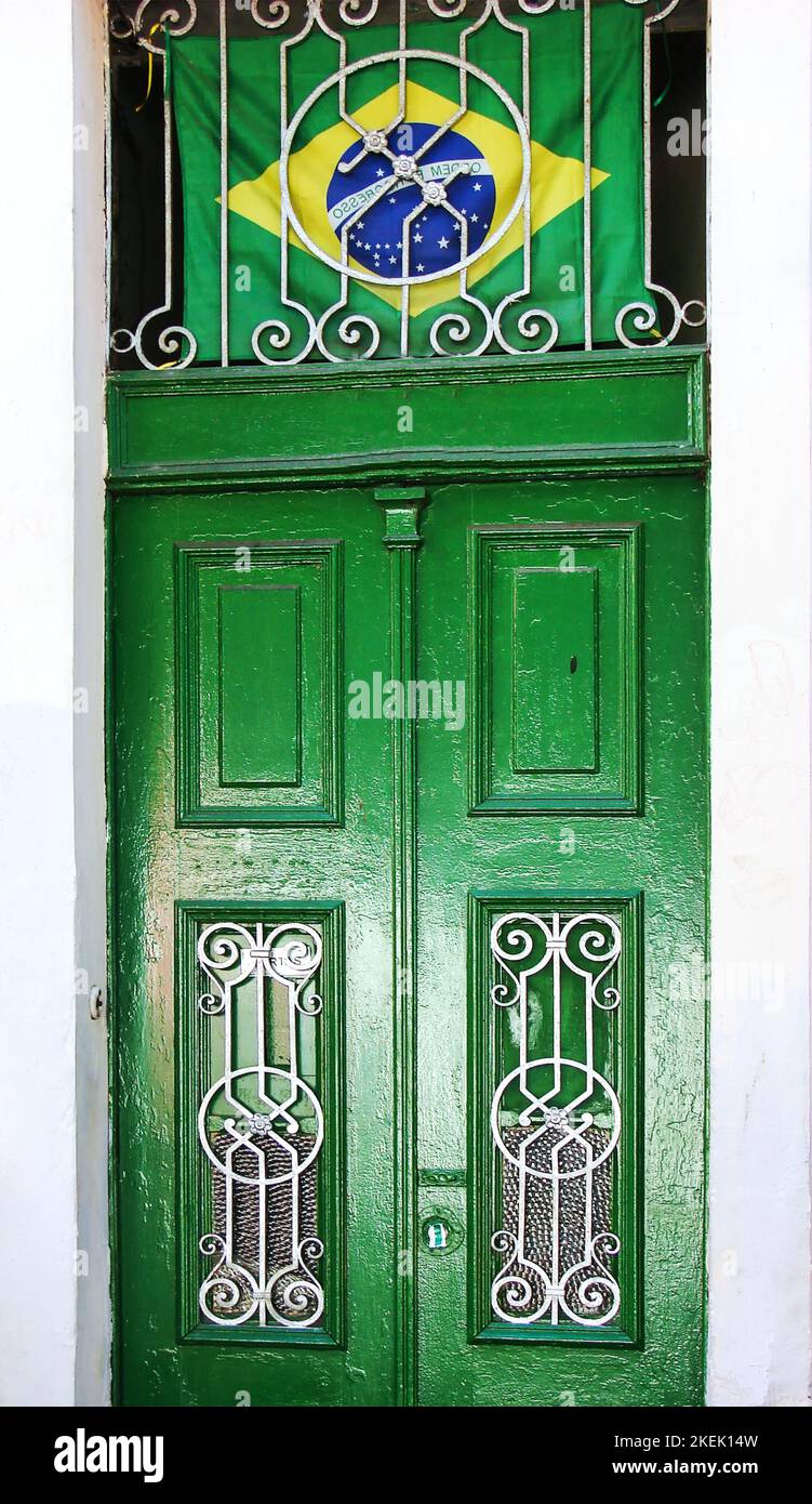 Green front door with the Brazilian flag in one of the neighborhoods of ...