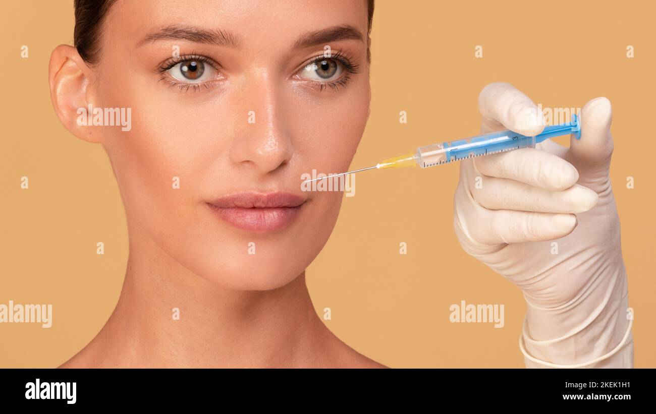Beauty injection concept. Closeup of doctor hands with syringe near ...