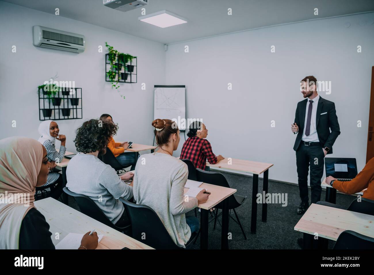 Group of young diverse people gathered together having a work ...