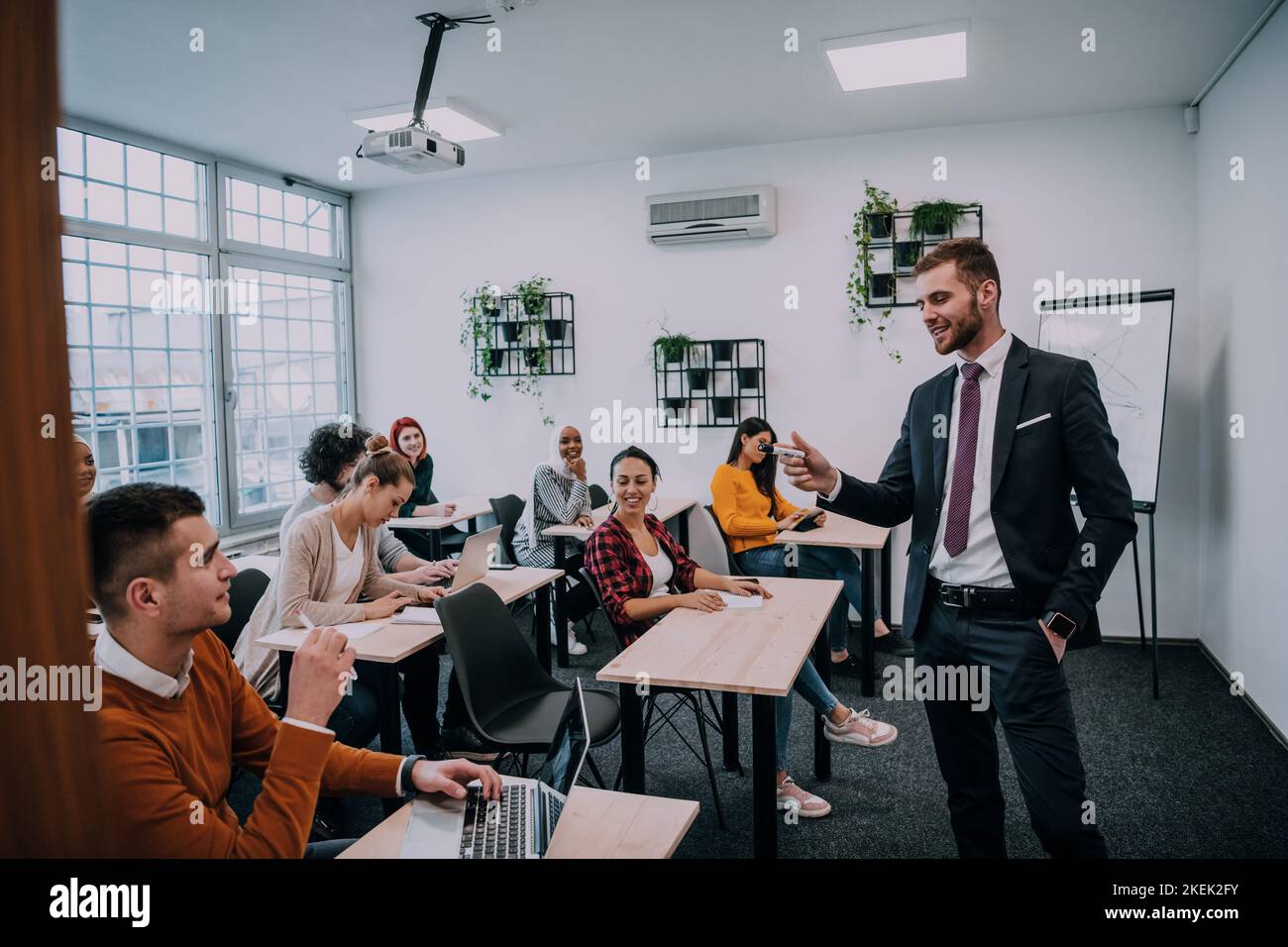 Group of young diverse people gathered together having a work ...