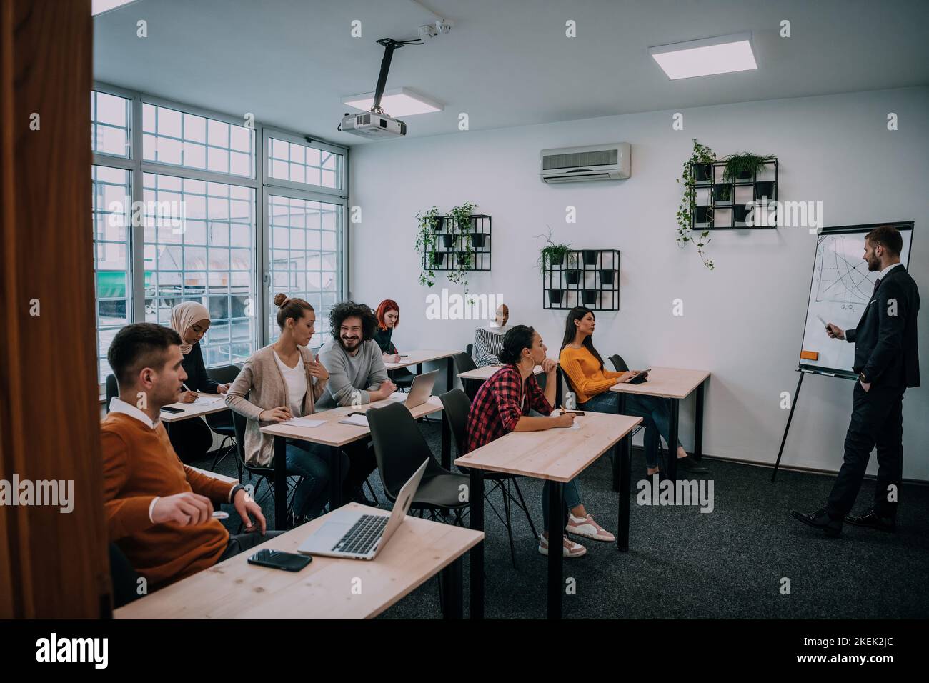Group of young diverse people gathered together having a work ...