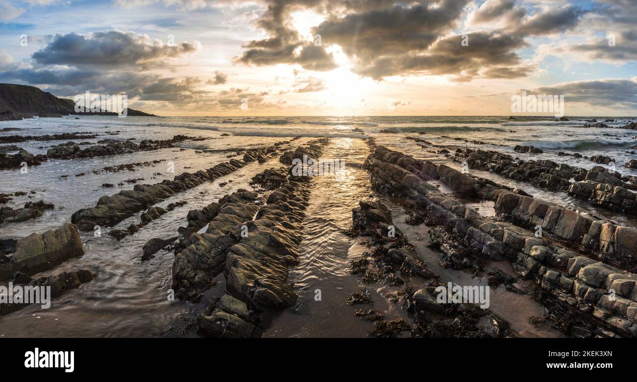 Stunning sunset landscape image of Welcome Mouth Beach in Devon England ...