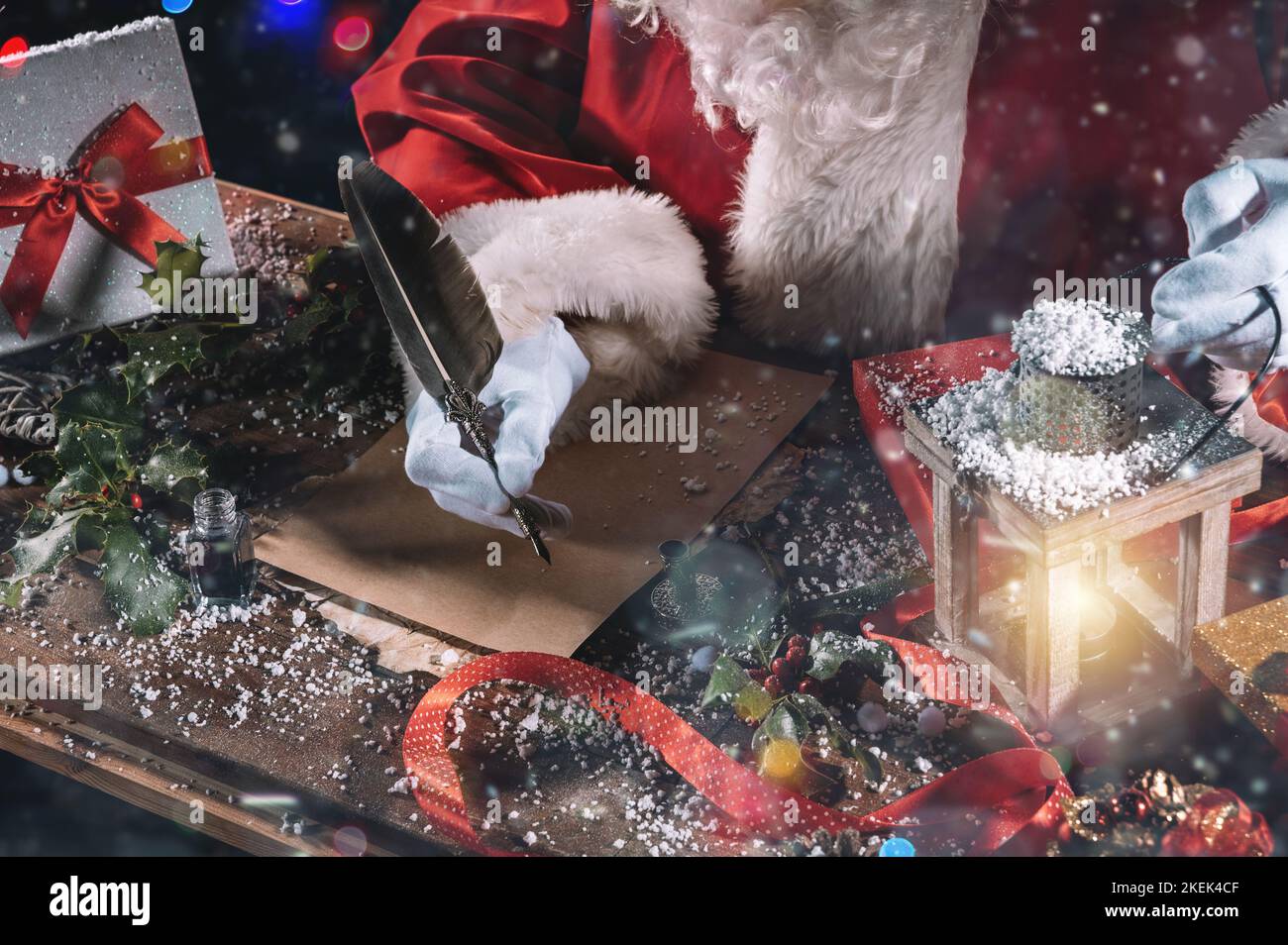 Santa claus writes a letter good wishes for Christmas gifts Stock Photo ...