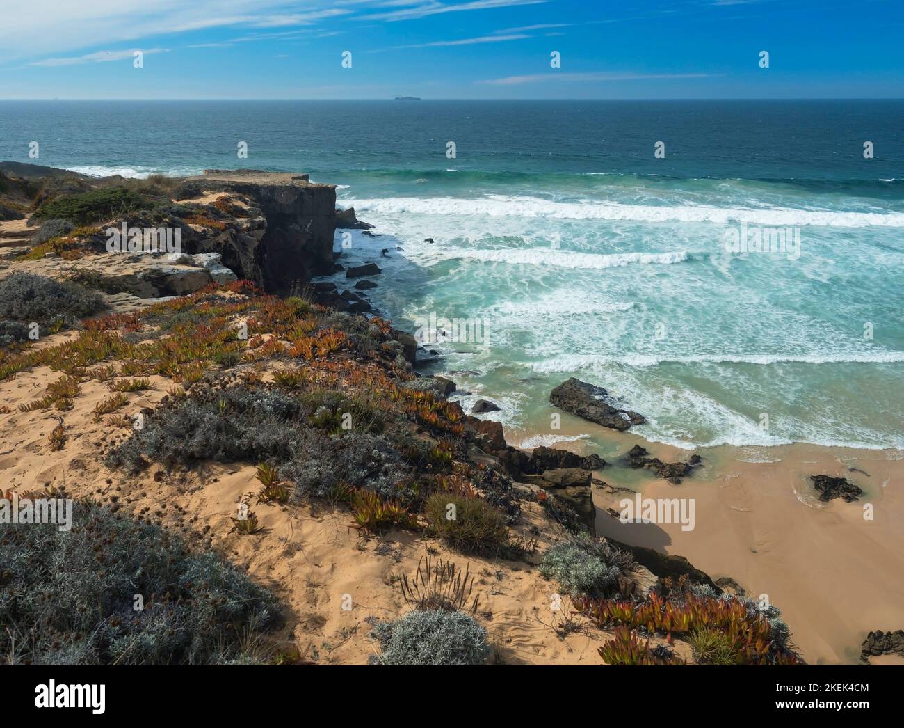 View of Praia dos Aivados sand beach with ocean waves and sharp rock ...