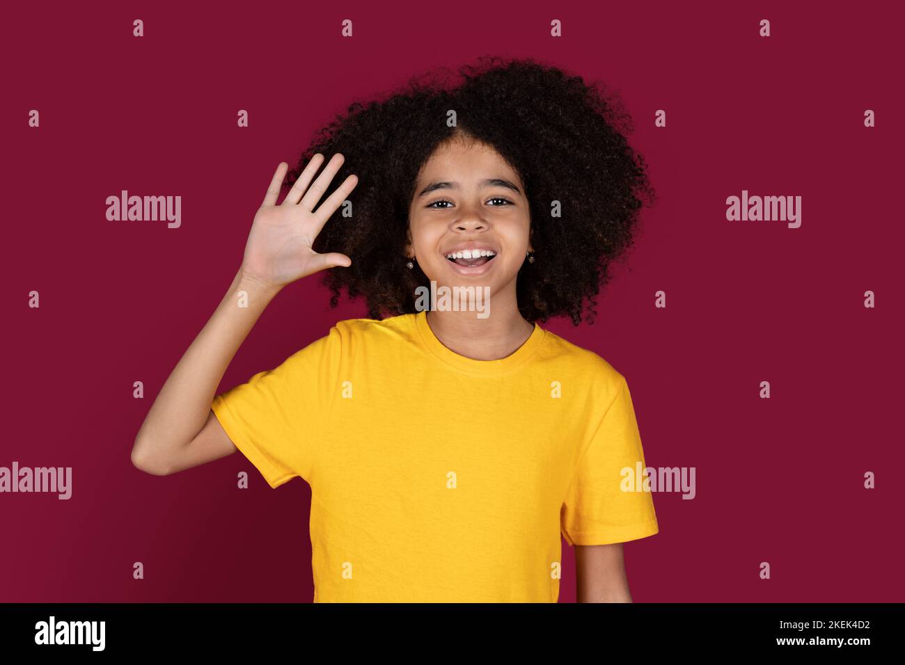 Portrait of cheerful african american kid girl waving at camera Stock ...