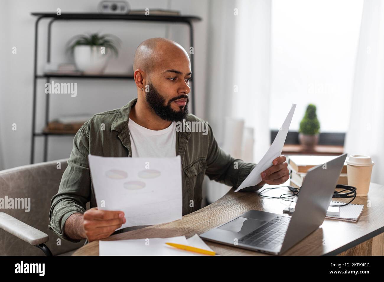 Paperwork concept. Focused mature latin man working at home office ...
