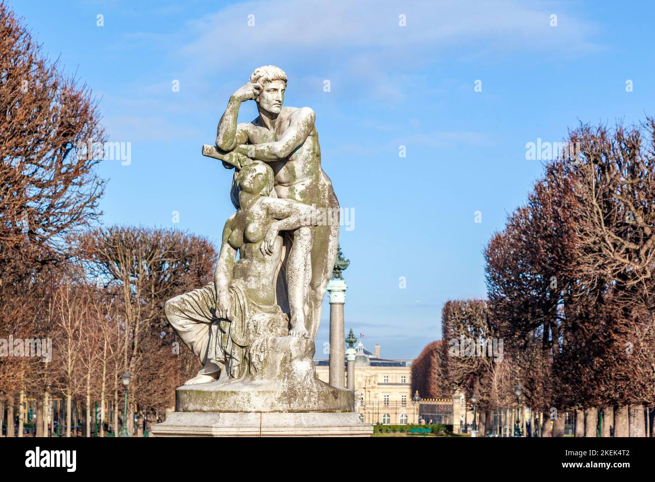 Statue of a standing man resting his arm above the head of a seated ...