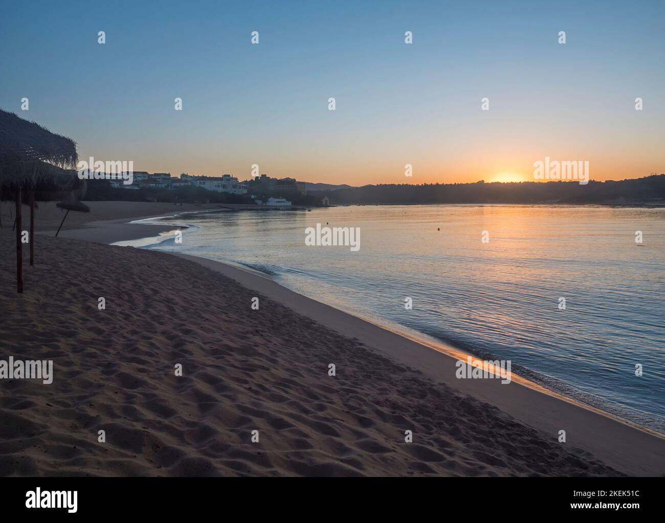 Orange sunrise at empty sand beach Praia da Franquia at Vila Nova de ...