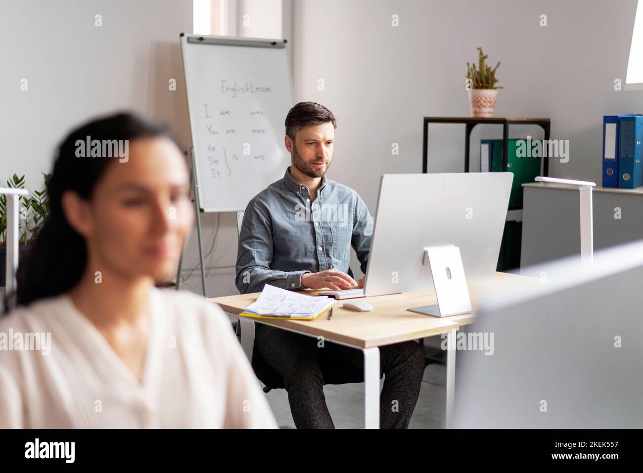 Serious busy handsome smiling millennial european woman and man ...