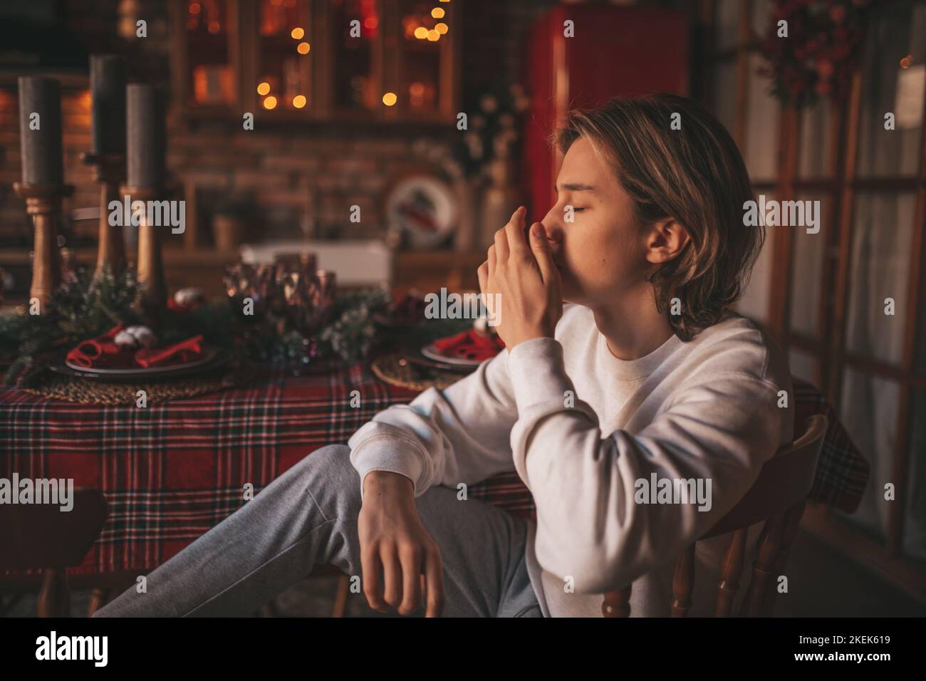 Young teen boy with long hair thoughtful look sad eyes negative mood ...