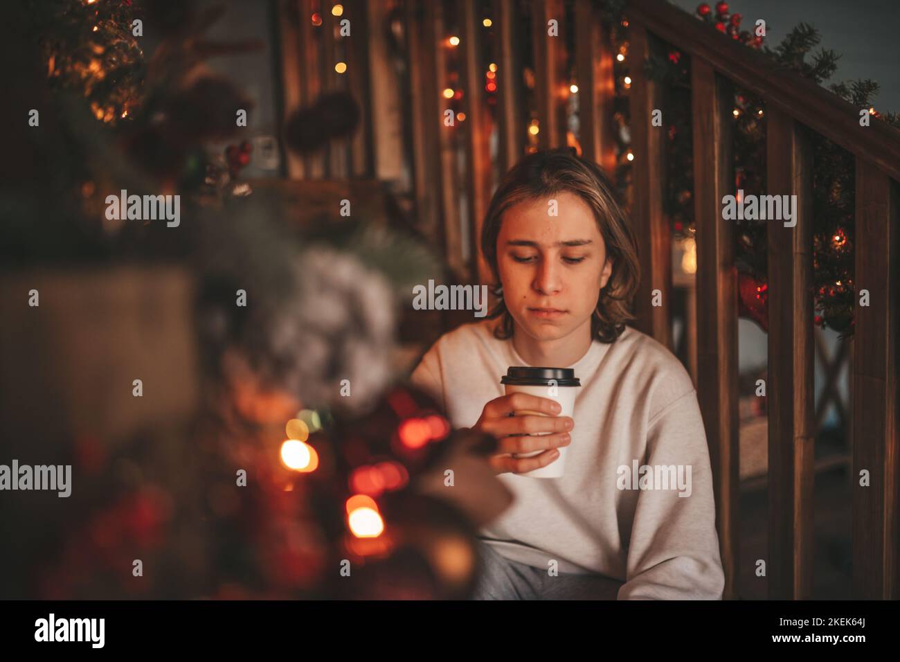 Young teen boy with long hair thoughtful look sad eyes negative mood ...