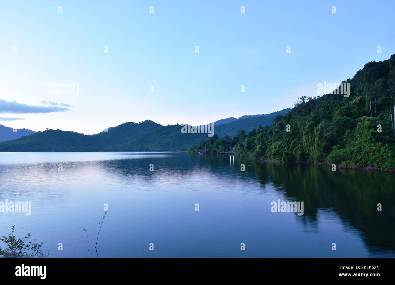 landscape of water reservoir lake with mountain background in sunset ...