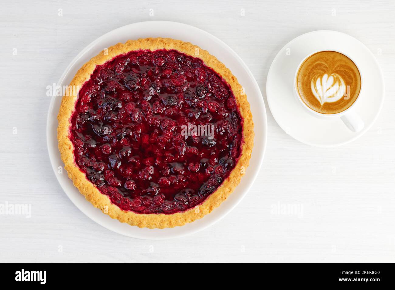 Homemade berry pie with cherry and cup of coffee cappuccino on white ...