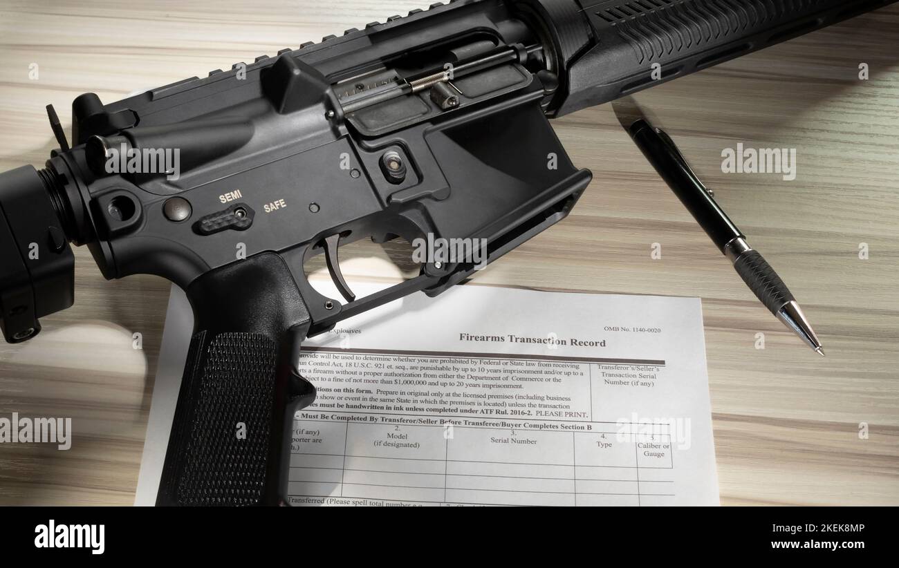 Assault rifle on safe with public domain background check form for its ...