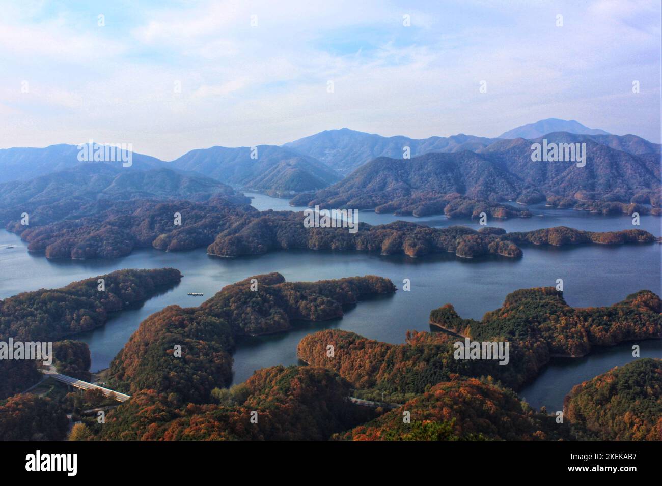 A scenic aerial view of hills and forests near the river in autumn ...