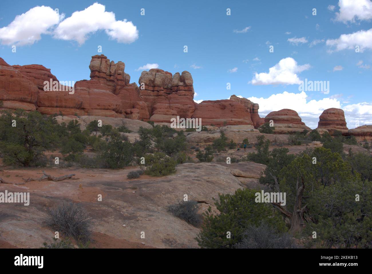 Two hikers traverse petrified sand dunes in Canyonlands National Park ...