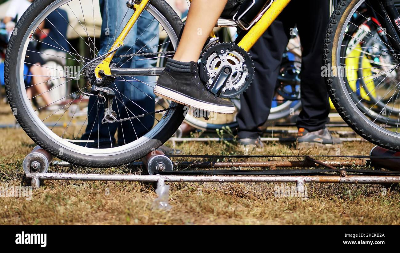 close-up, the wheels of an old exercise bike, the bike rides in one ...
