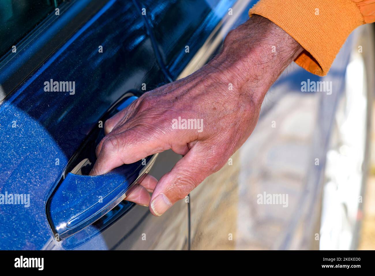 Hand of an old man about to open a car door Stock Photo - Alamy